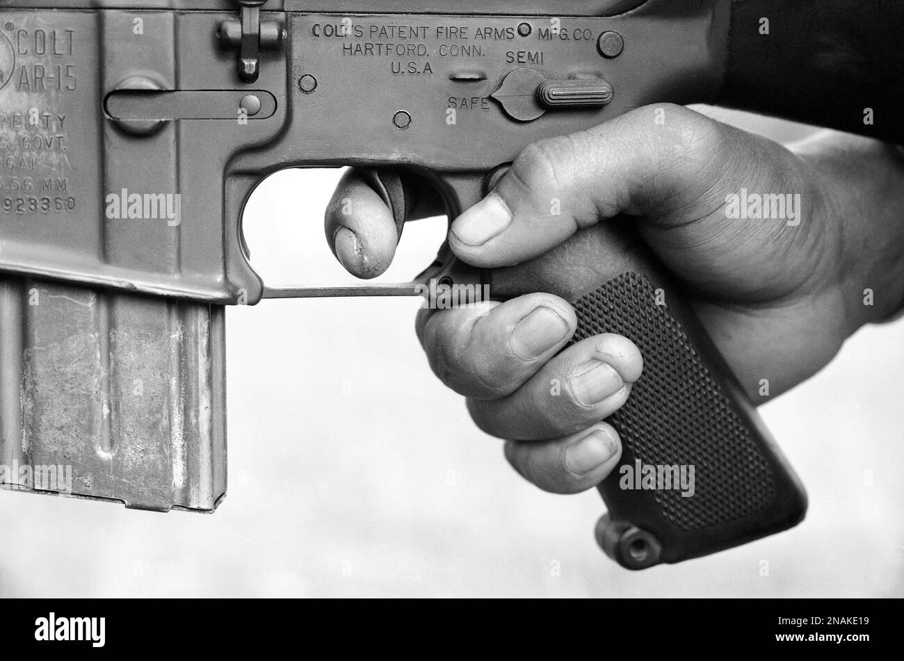 A government soldier squeezes the trigger before releasing the safety ...