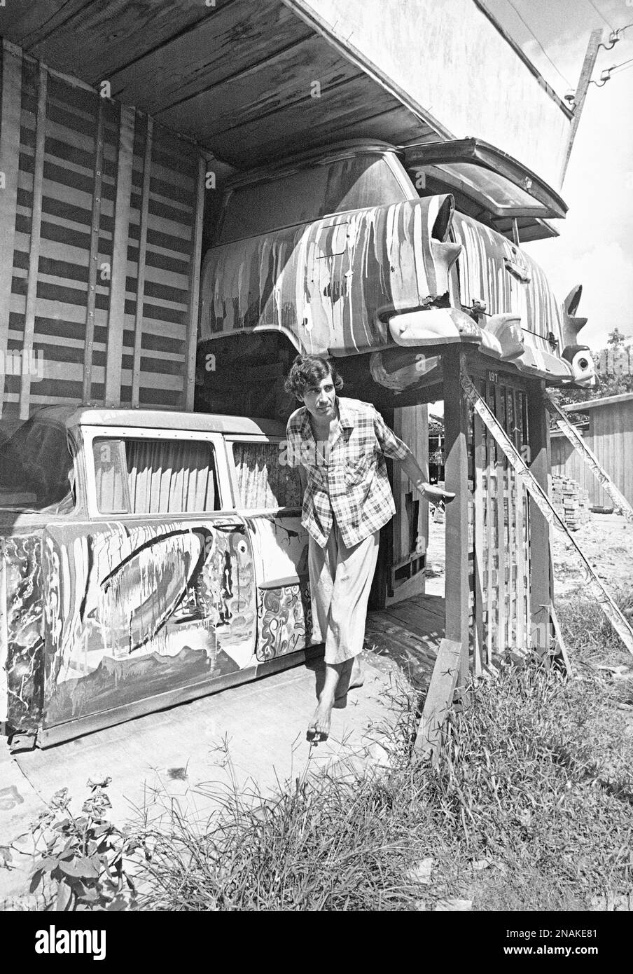 Max Leray, 33, stands in front of his house that consists of a wrecked ...