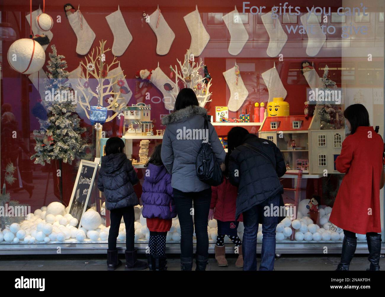 Shoppers look into a shop window on Oxford Street in London in the last ...
