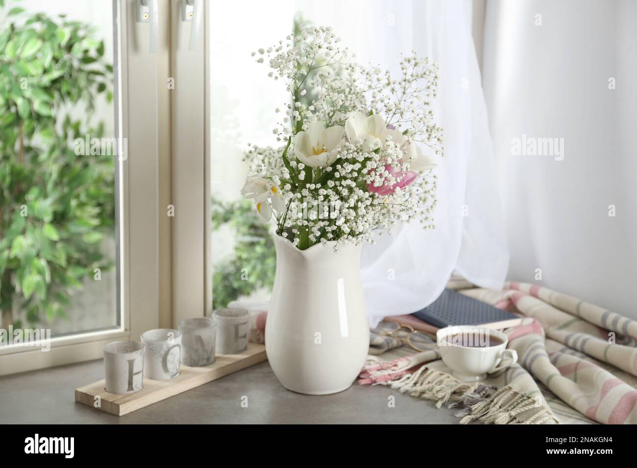 Beautiful fresh flowers on window sill indoors Stock Photo - Alamy