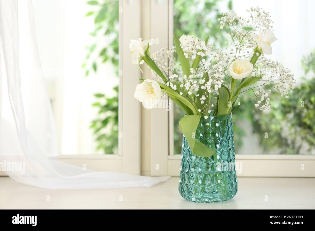 Beautiful fresh flowers on window sill indoors. Space for text Stock ...