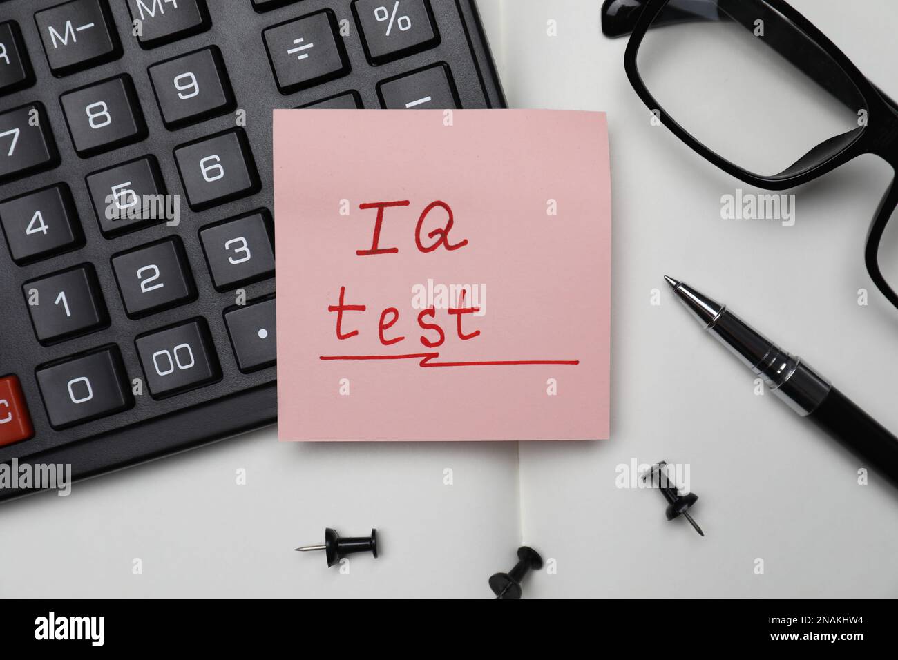 Paper with words IQ Test, calculator and pen on open notebook, flat lay ...