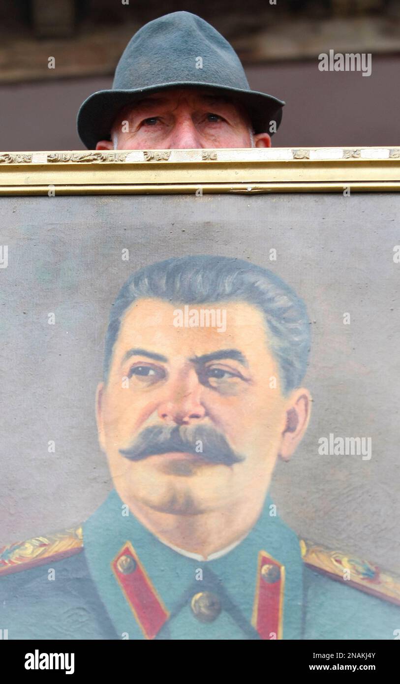 A Georgian man holds a portrait of Soviet dictator Joseph Stalin during ...