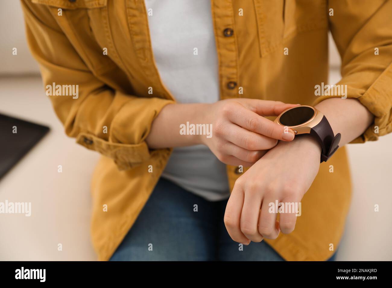 Woman checking watch home hi-res stock photography and images - Alamy