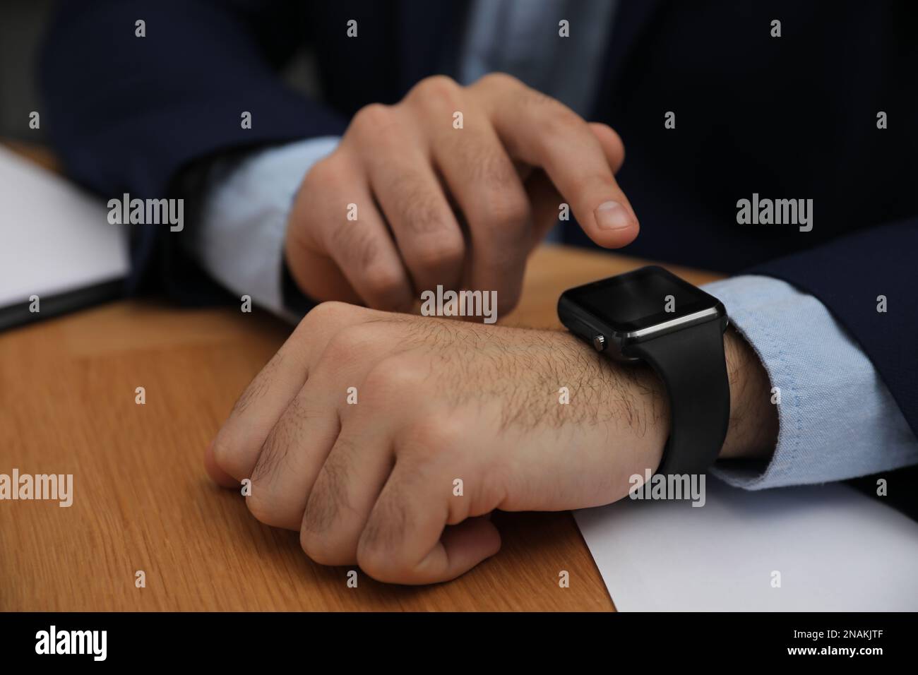 Man using smartwatch desk hi-res stock photography and images - Alamy