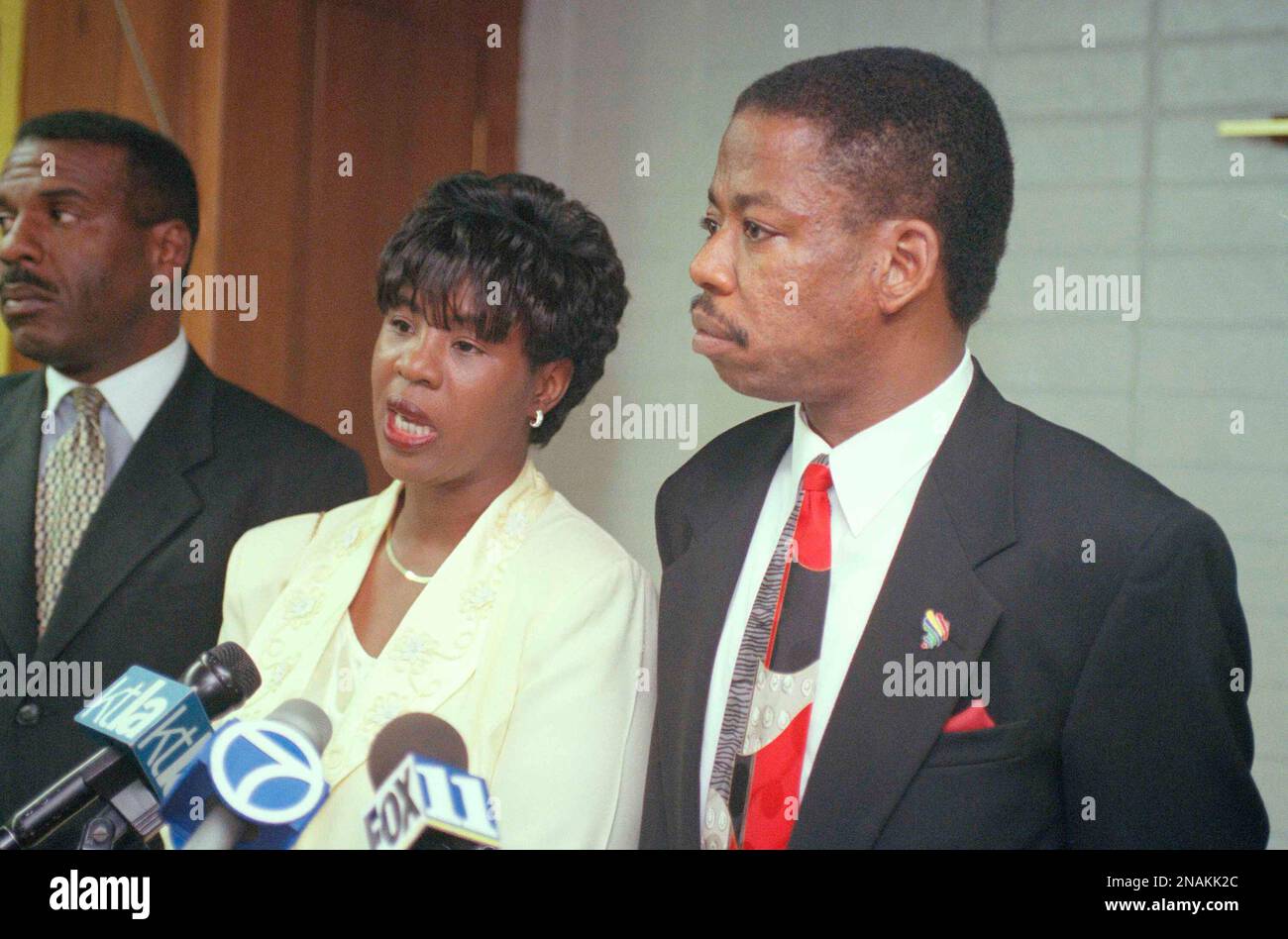 Debra Reid stands by her attorney Carl E. Douglas during a news ...