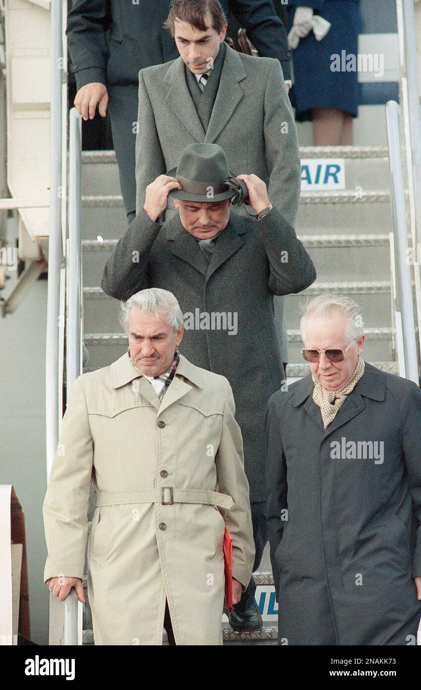Soviet leader Mikhail Gorbachev holds onto his hat in a strong wind, as ...