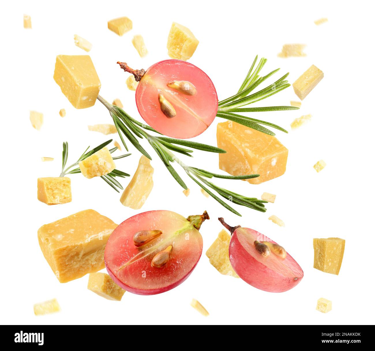 Pieces of delicious parmesan, grapes and rosemary falling on white ...