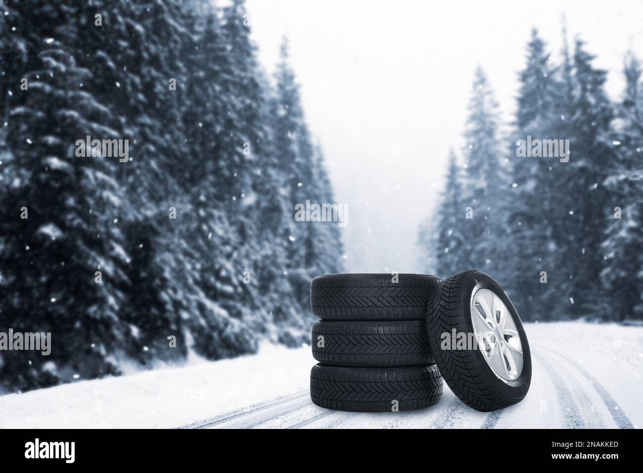 Set of wheels with winter tires outdoors on snowy road Stock Photo - Alamy