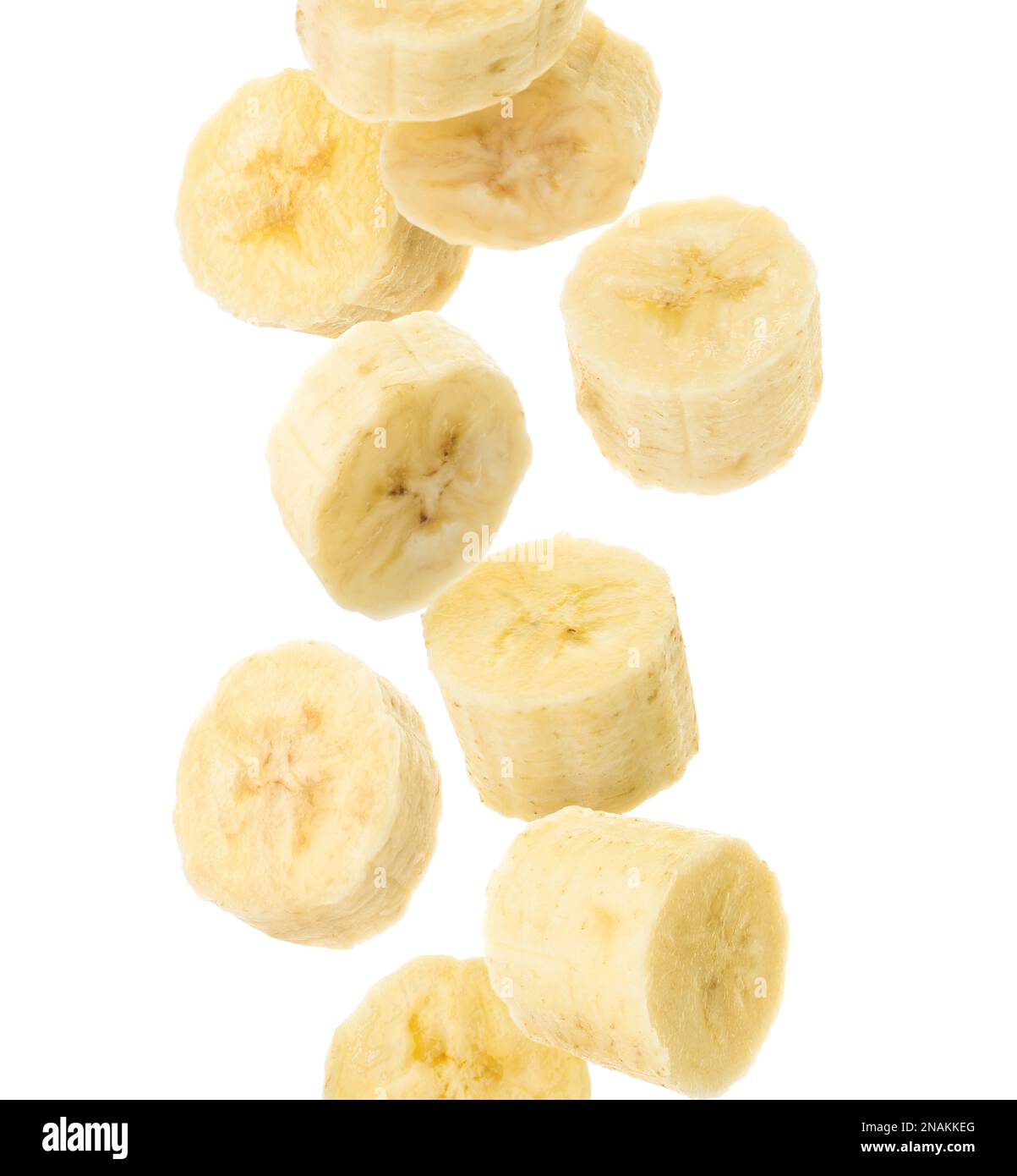 Slices of tasty ripe banana falling on white background Stock Photo - Alamy