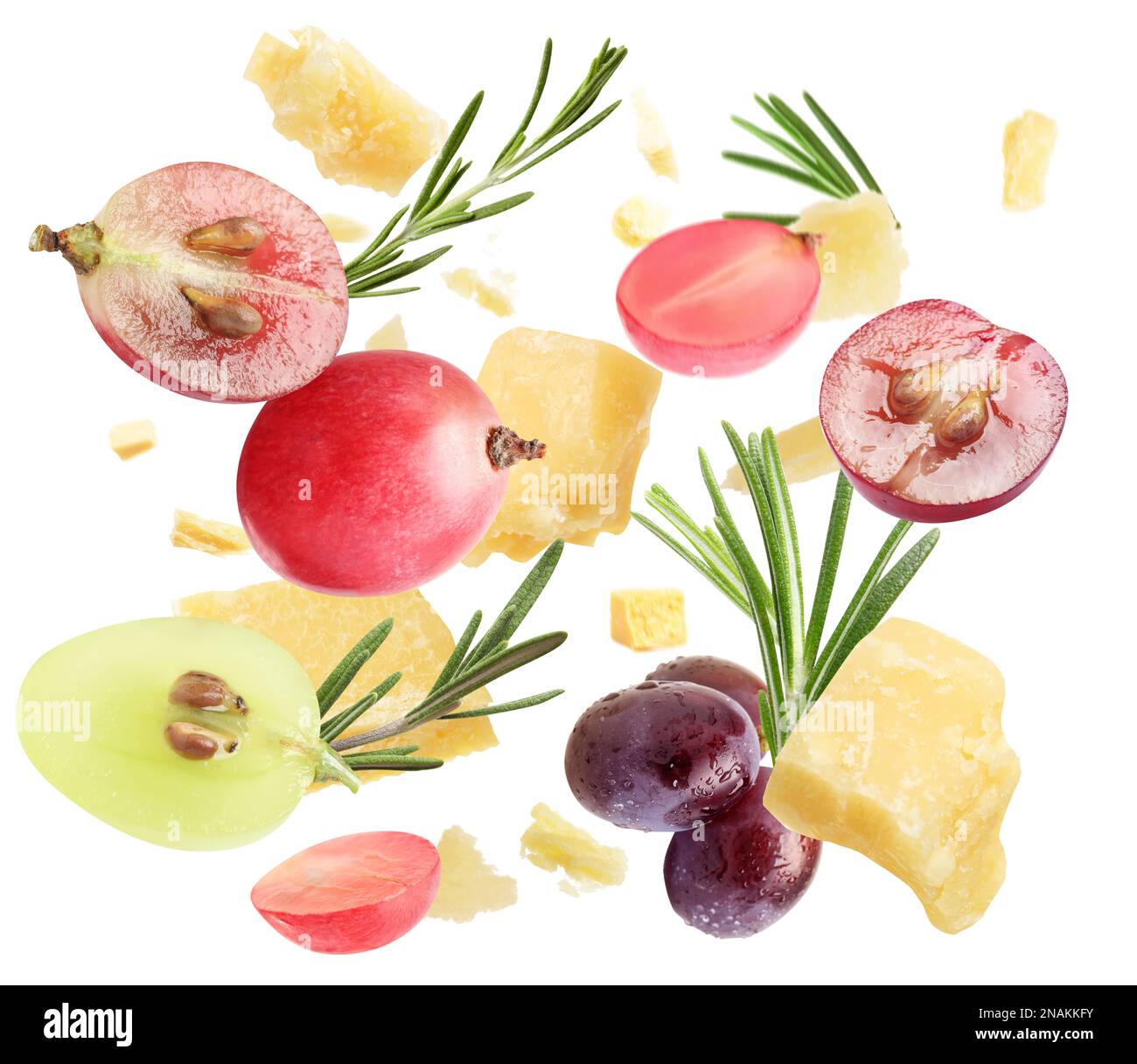 Pieces of delicious parmesan, grapes and rosemary falling on white ...