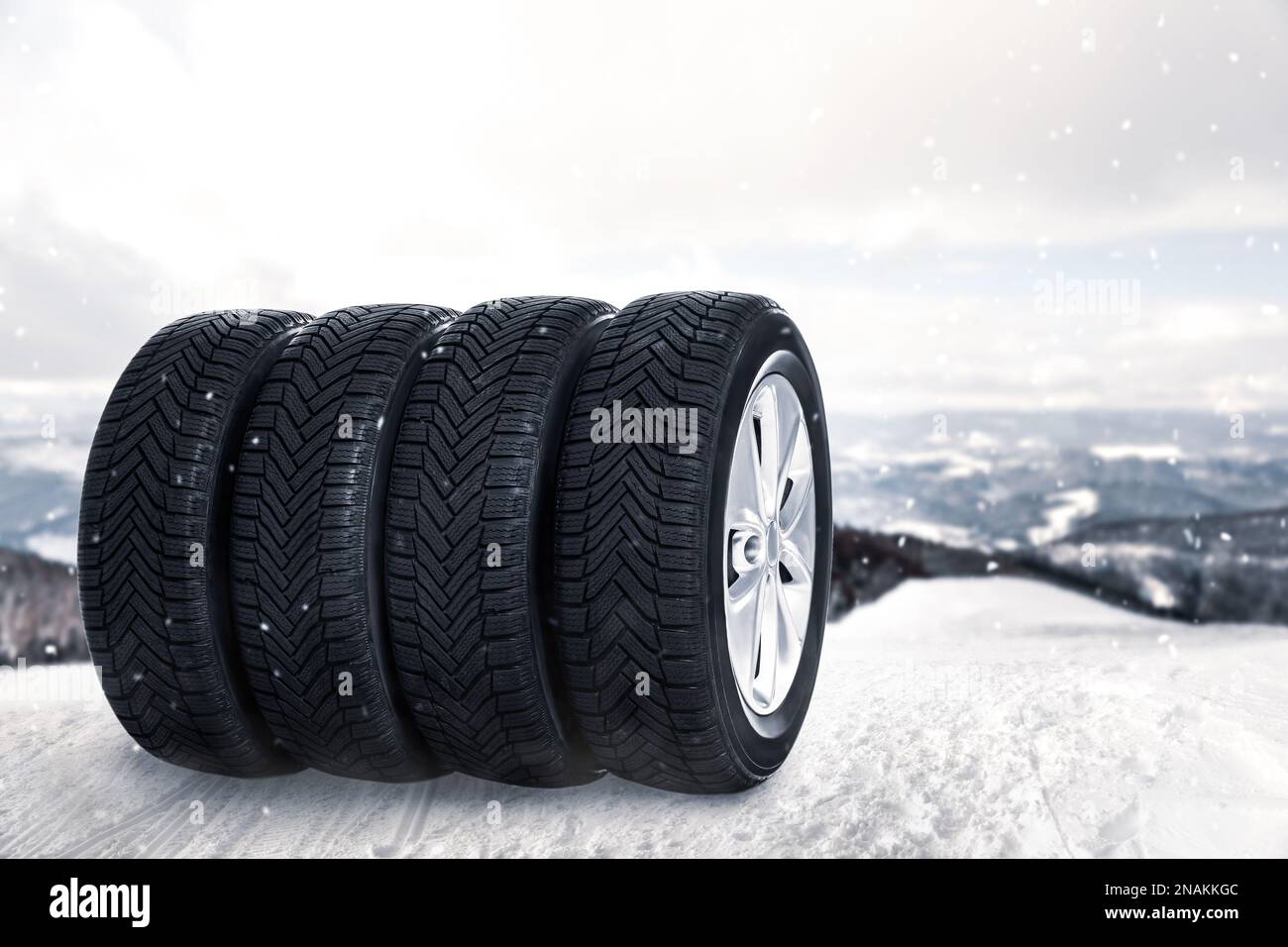 Set of wheels with winter tires outdoors on snow Stock Photo - Alamy