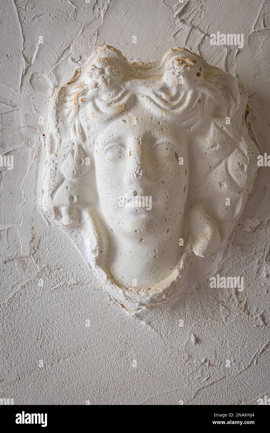 Stone carving of a face, on wall Stock Photo - Alamy
