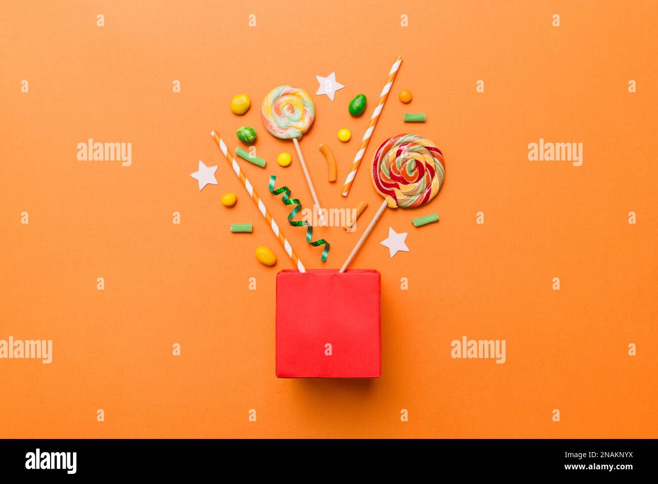 gift box in corner full of assorted traditional candies falling out on ...