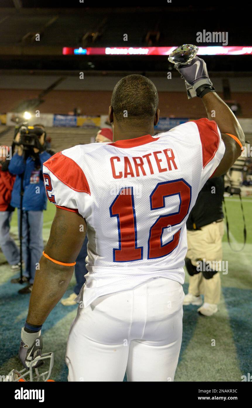 Syracuse's Delone Carter (12) holds the trophy for being named the offensive MVP after the East ...