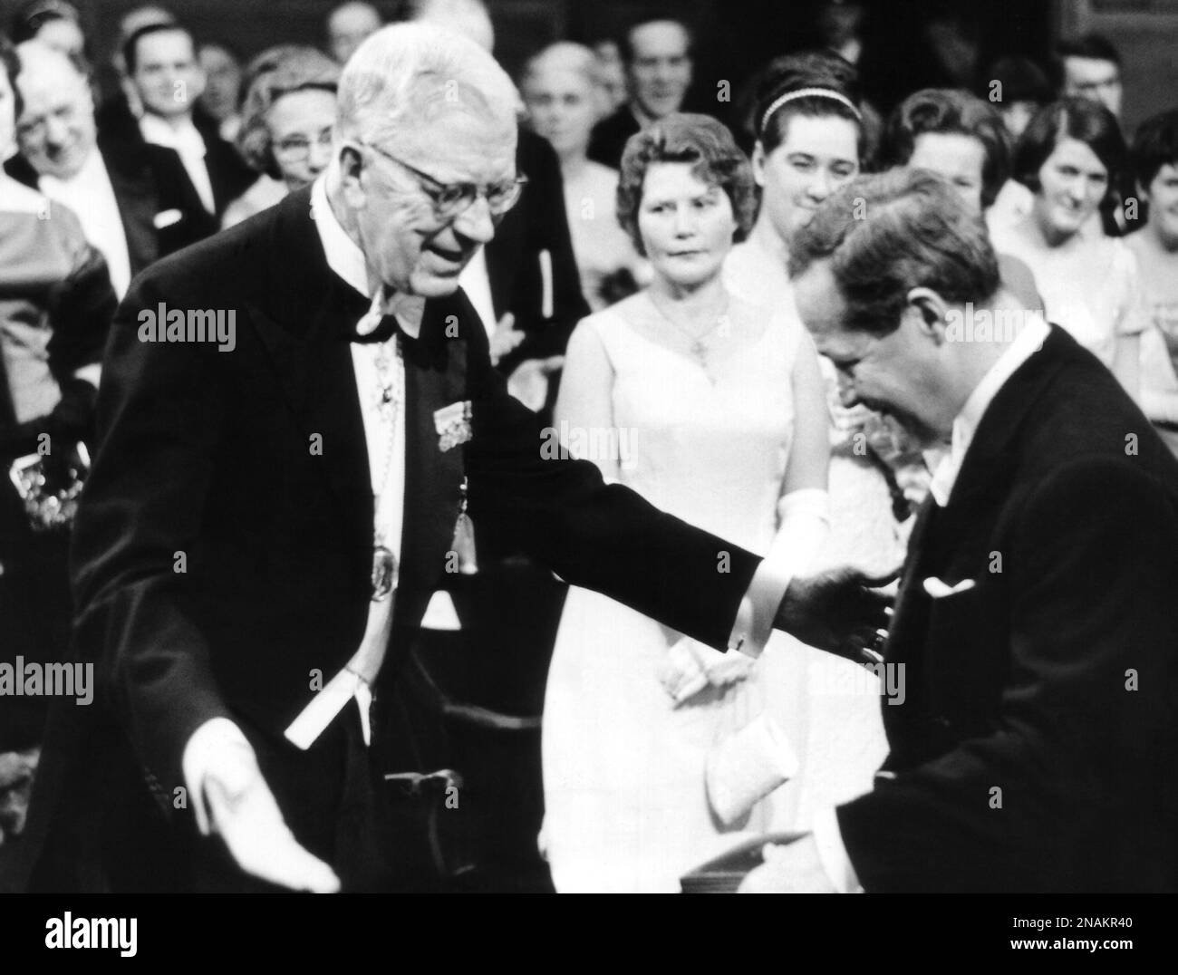King Gustaf Adolf of Sweden hands over the Nobel Prize in Medicine to ...