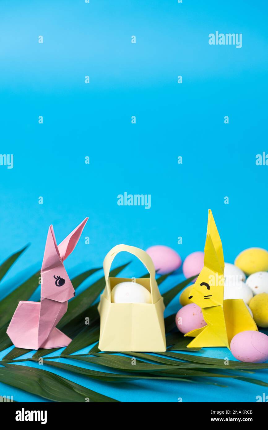 Two figures of Easter bunnies made of paper, origami crafts and a ...