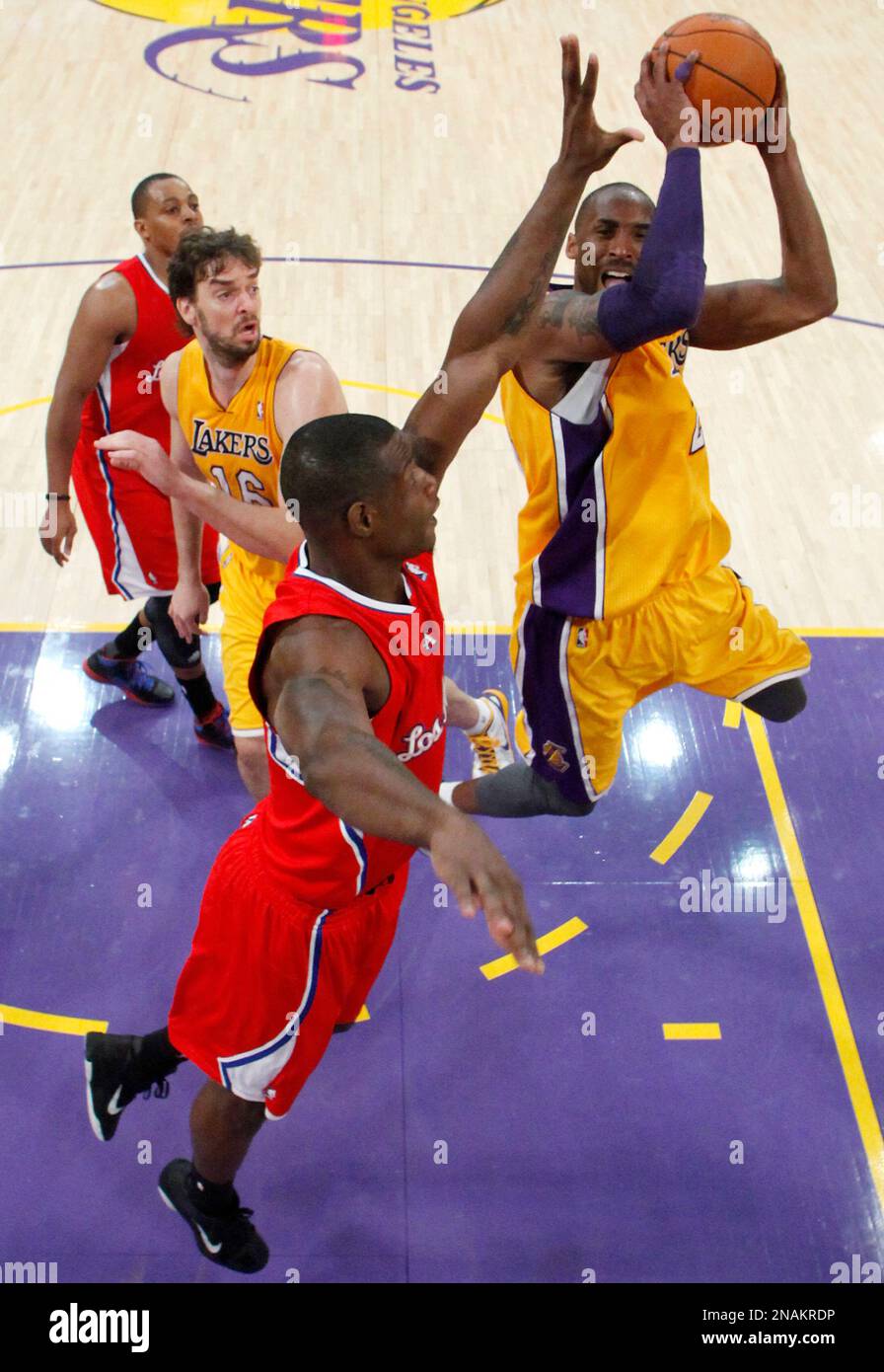 Los Angeles Lakers' Kobe Bryant, right, looks to shoot over Los Angeles ...
