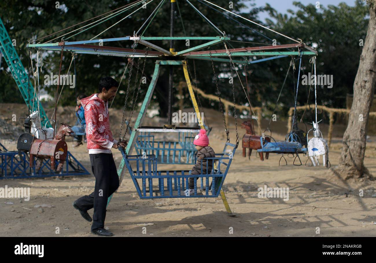 A Pakistani child enjoys a ride, in a Christian neighborhood in ...