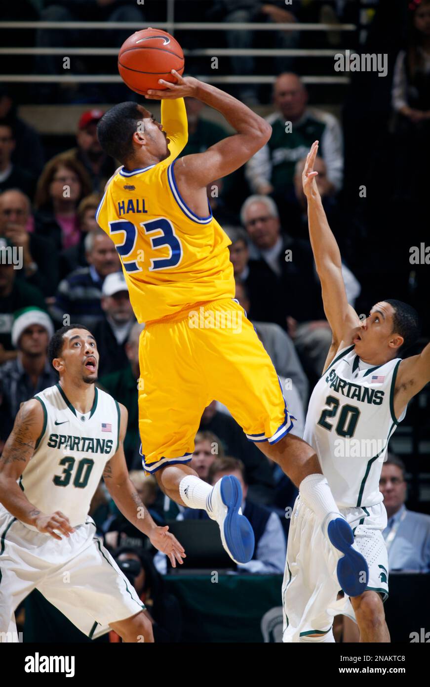 Missouri-Kansas City's Trinity Hall (23) shoots between Michigan State ...