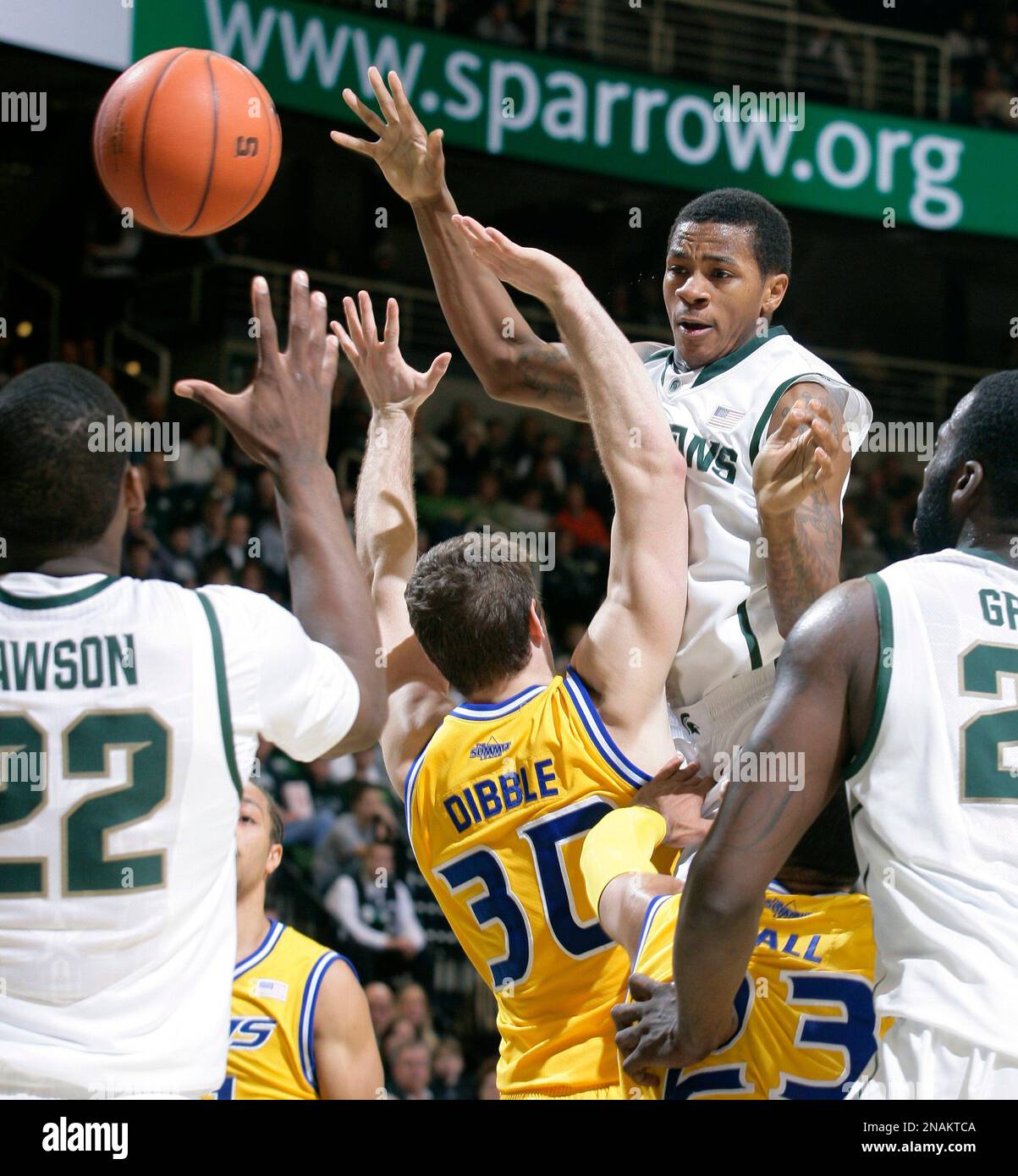 Michigan State's Keith Appling, top right, dishes to Branden Dawson ...
