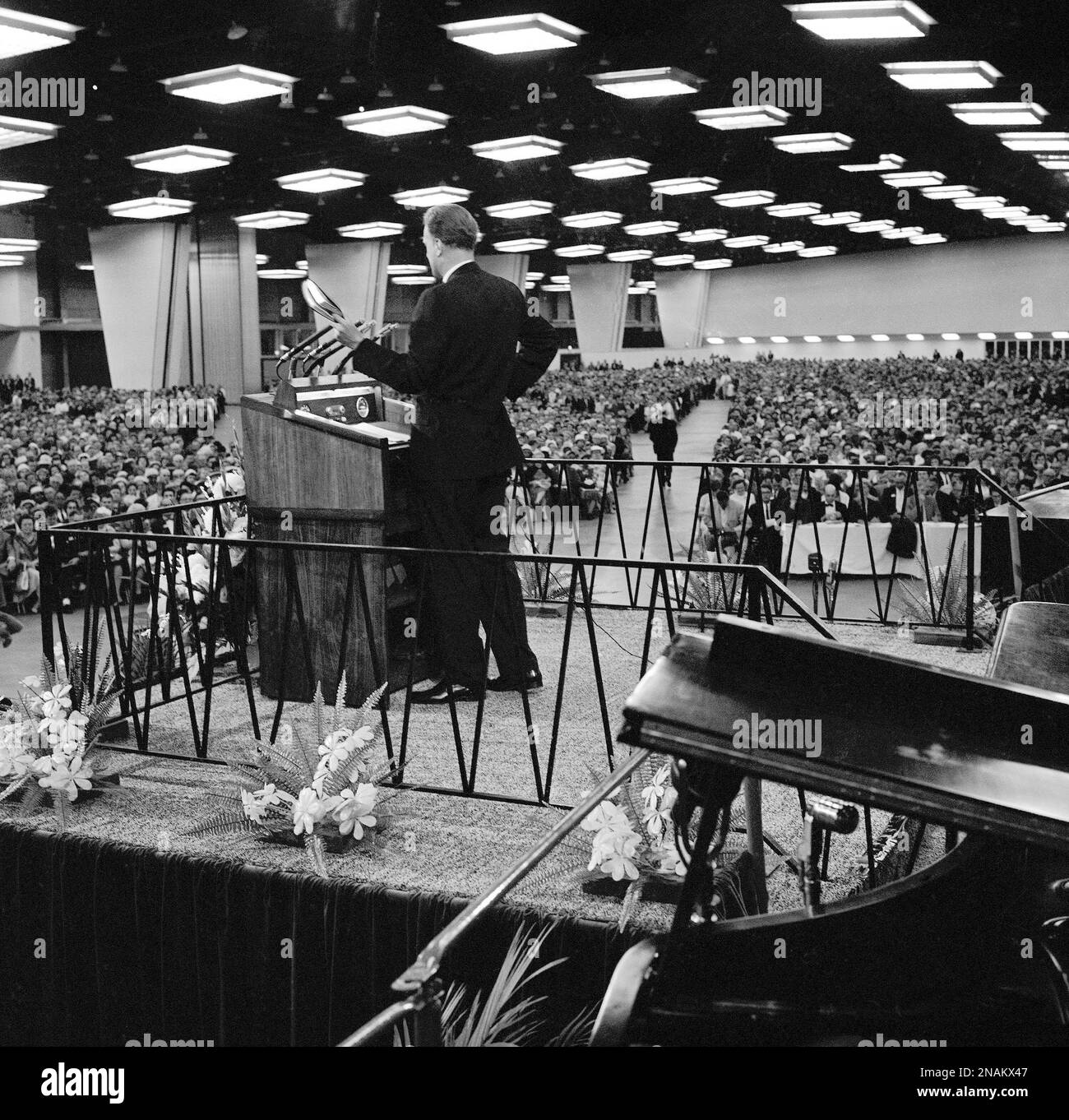 Holding a Bible in his hand, Evangelist Billy Graham speaks to a ...
