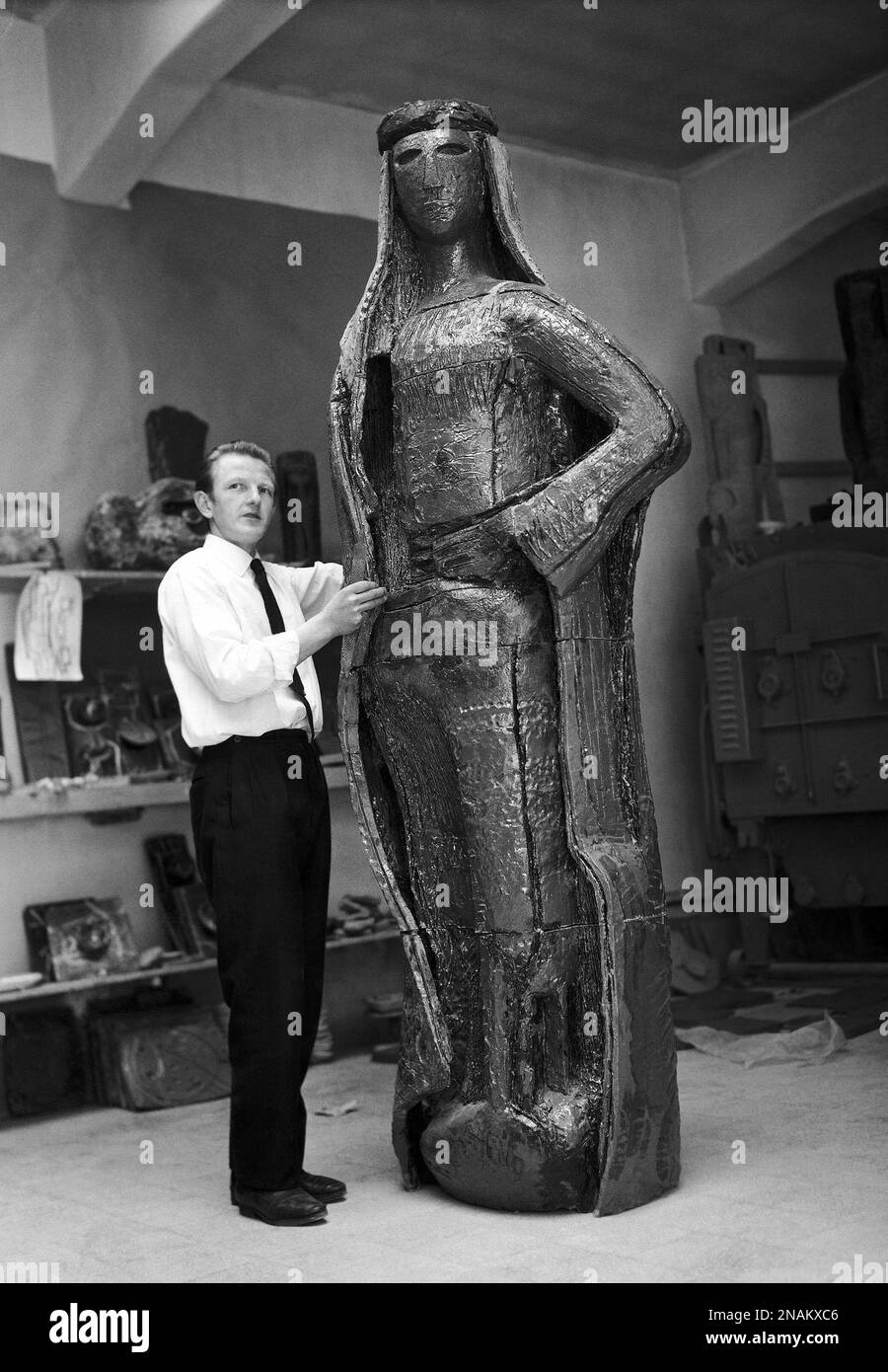 Luigi Gheno, the famed Italian sculptor, stands beside the nearly-twice ...