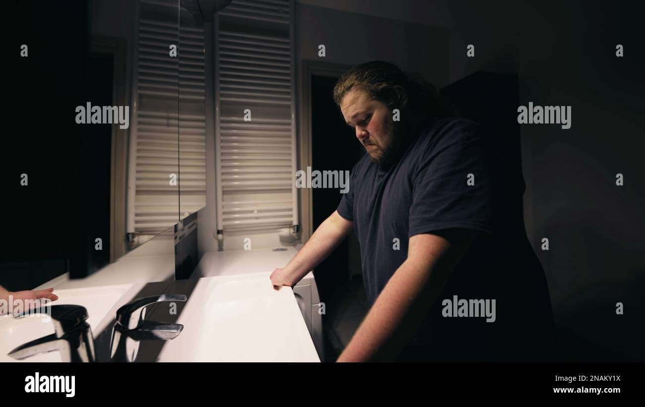 Man staring bathroom mirror suffering hi-res stock photography and ...