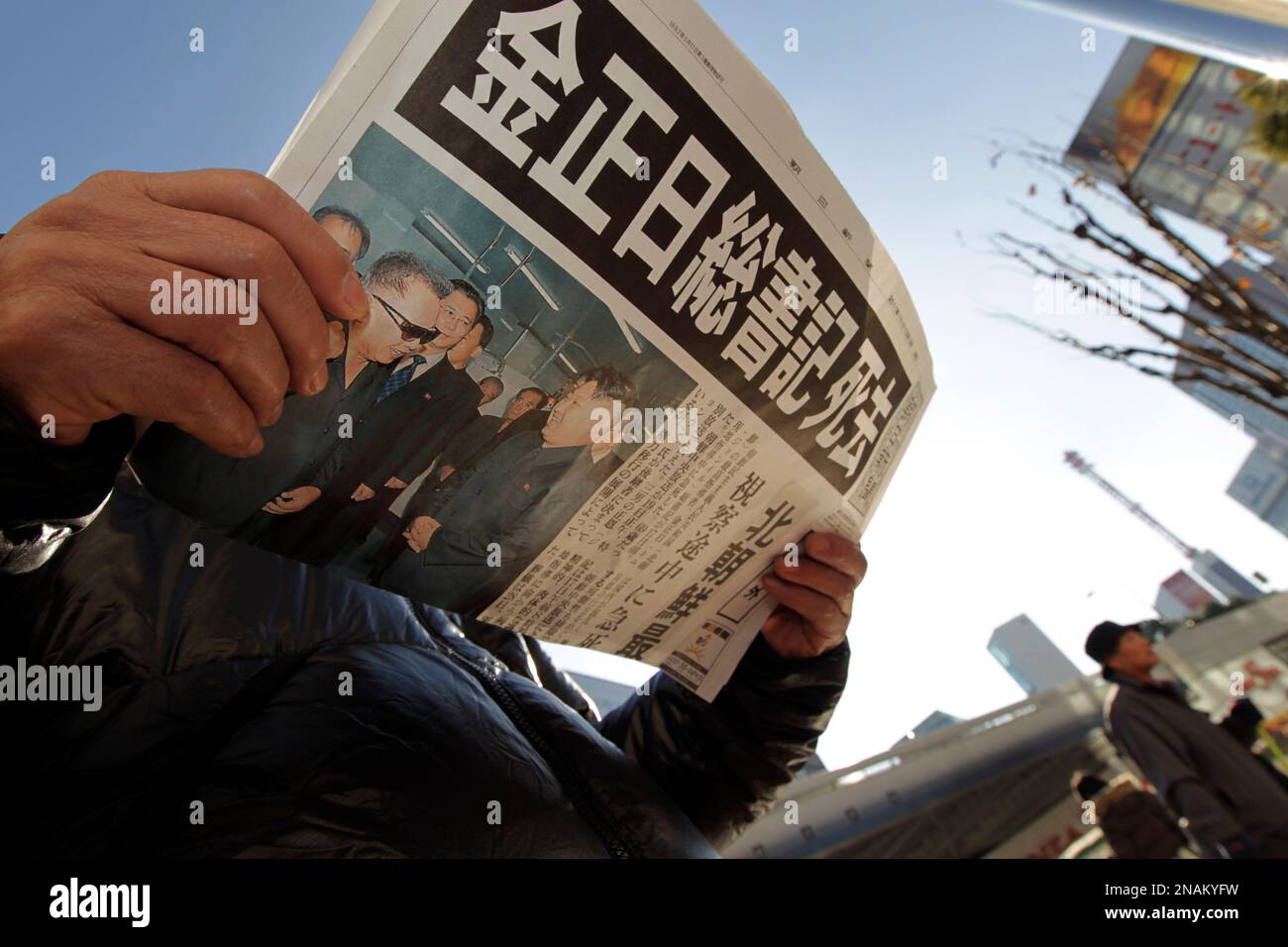 A man reads an extra issue of a Japanese newspaper at Ginza district in ...