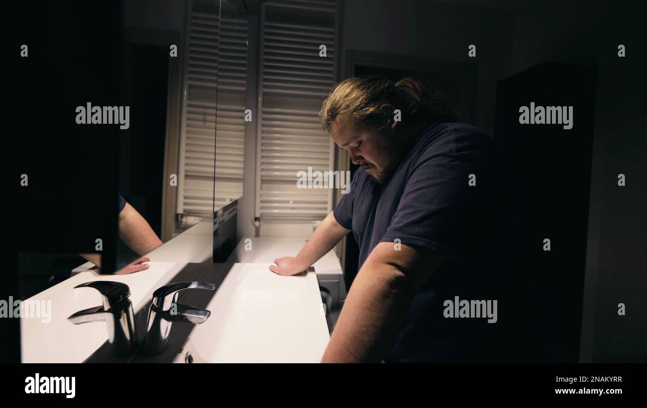 Man staring bathroom mirror suffering hi-res stock photography and ...