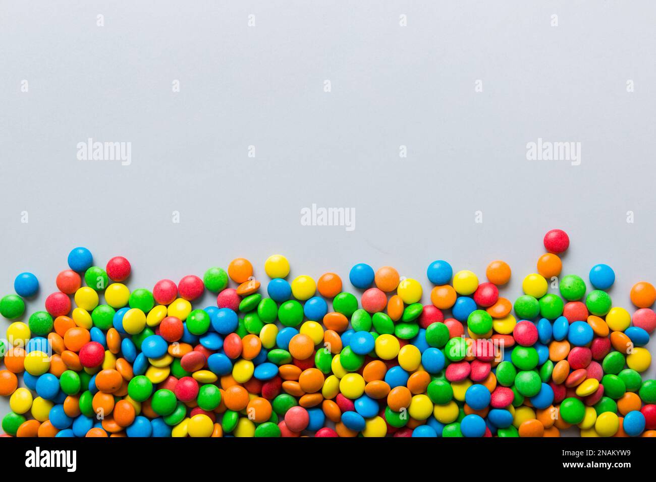 Mixed collection of colorful candy, on colored background. Flat lay ...