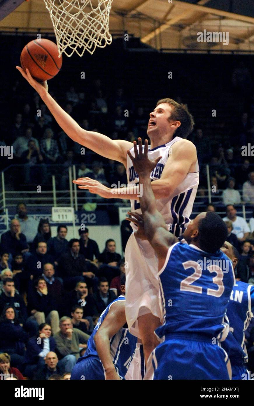 Northwestern's John Shurna (24) shoots over Eastern Illinois' L.C. Doss ...