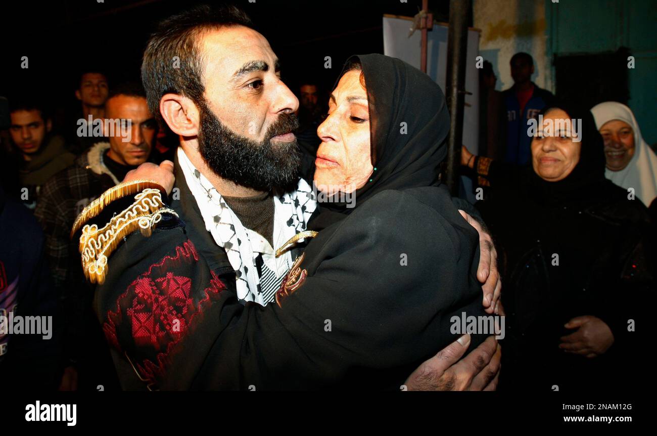 Subhi Jadallah, 35, a released Palestinian prisoner, left, hugs his ...