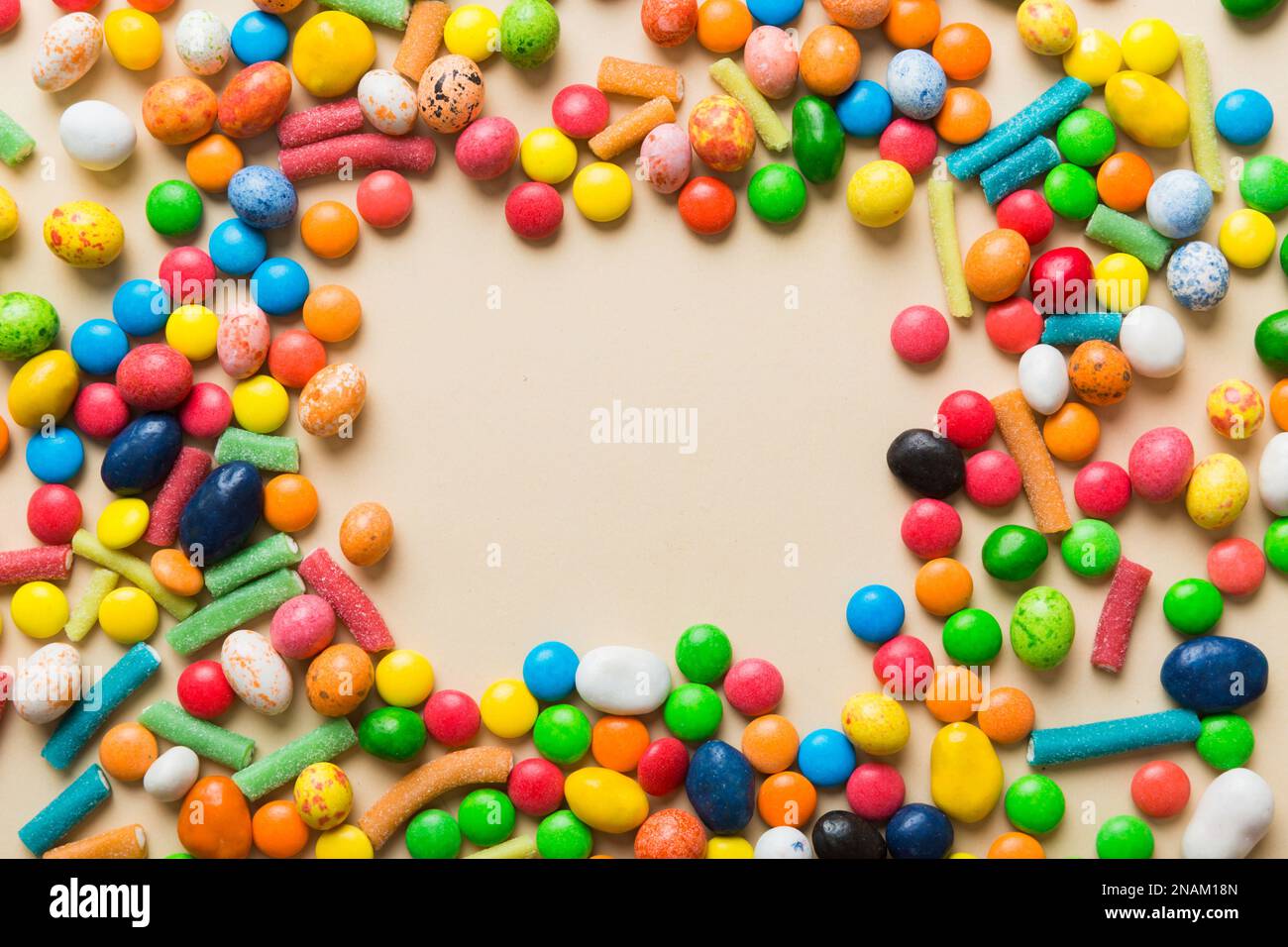 Mixed collection of colorful candy, on colored background. Flat lay ...