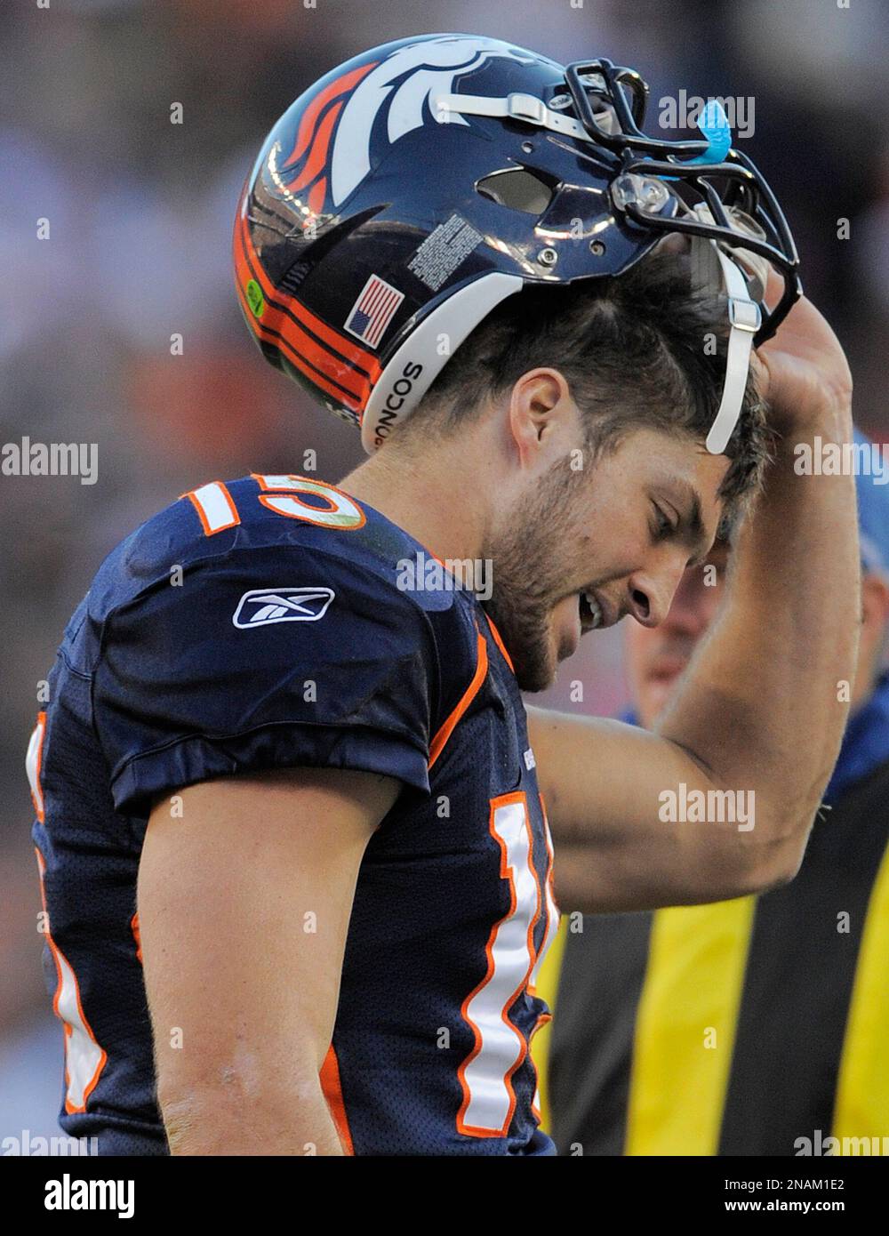 Denver Broncos quarterback Tim Tebow (15) walks off the field after ...