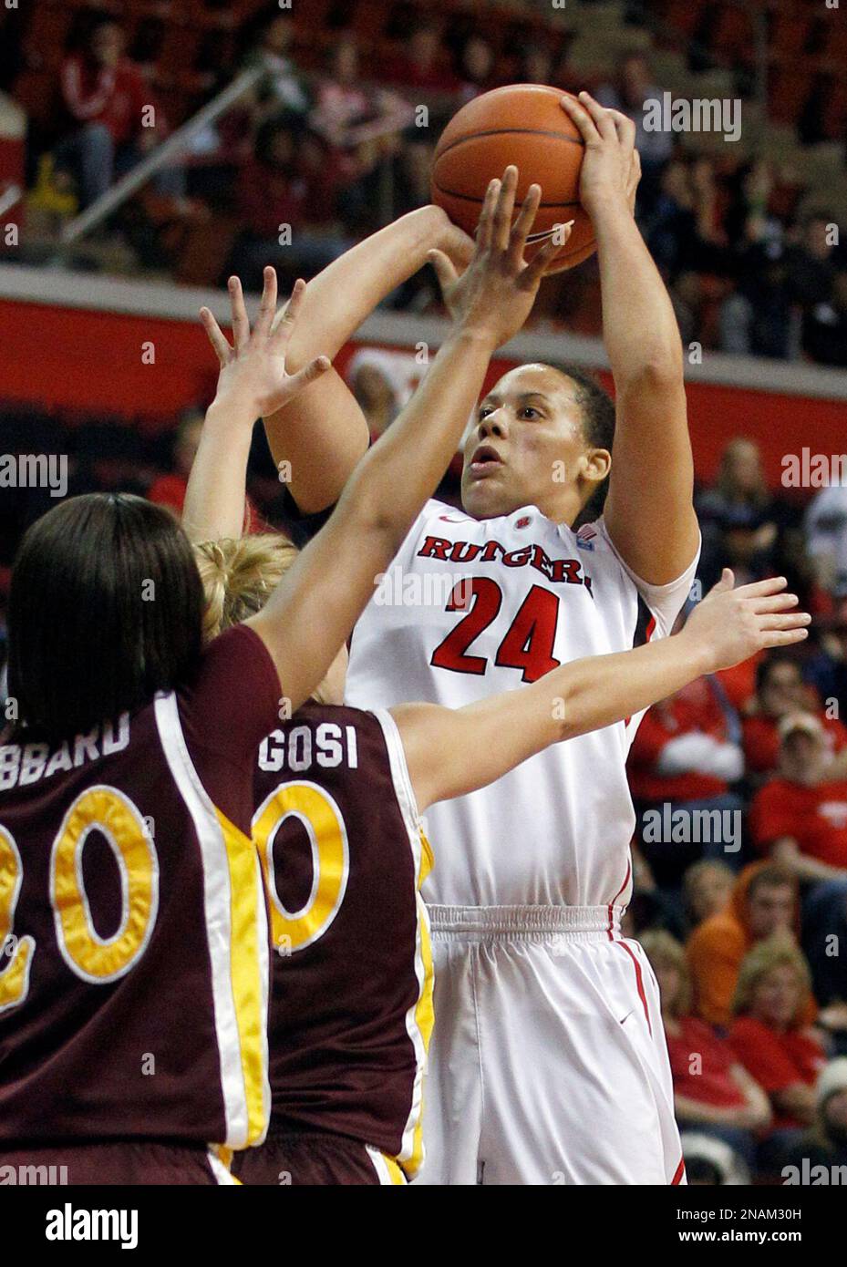 Rutgers' April Sykes (24) takes a shot past Iona's Diana Hubbard, left ...