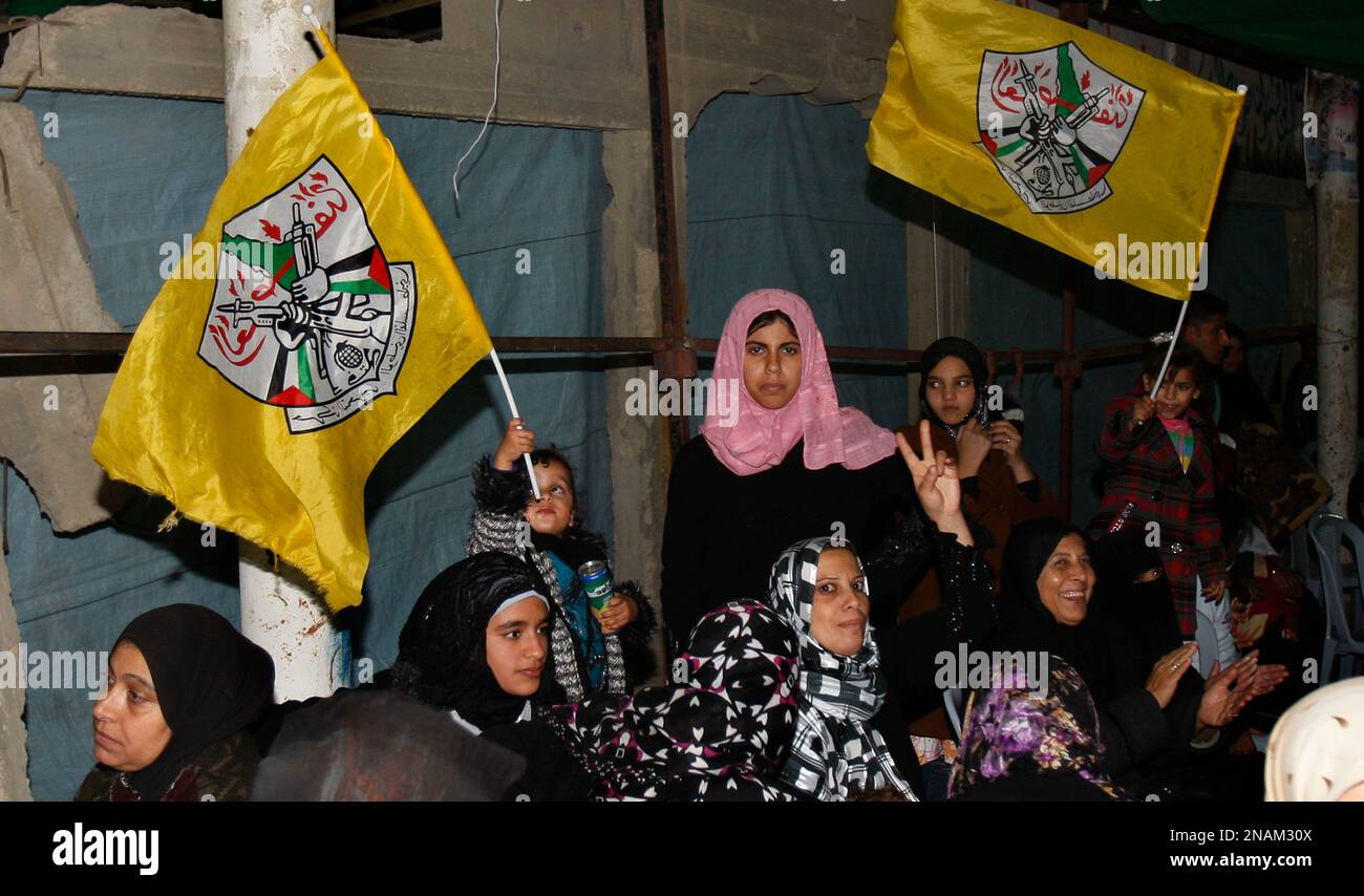 Palestinians women wave yellow Fatah flags as they celebrate at Rafah ...
