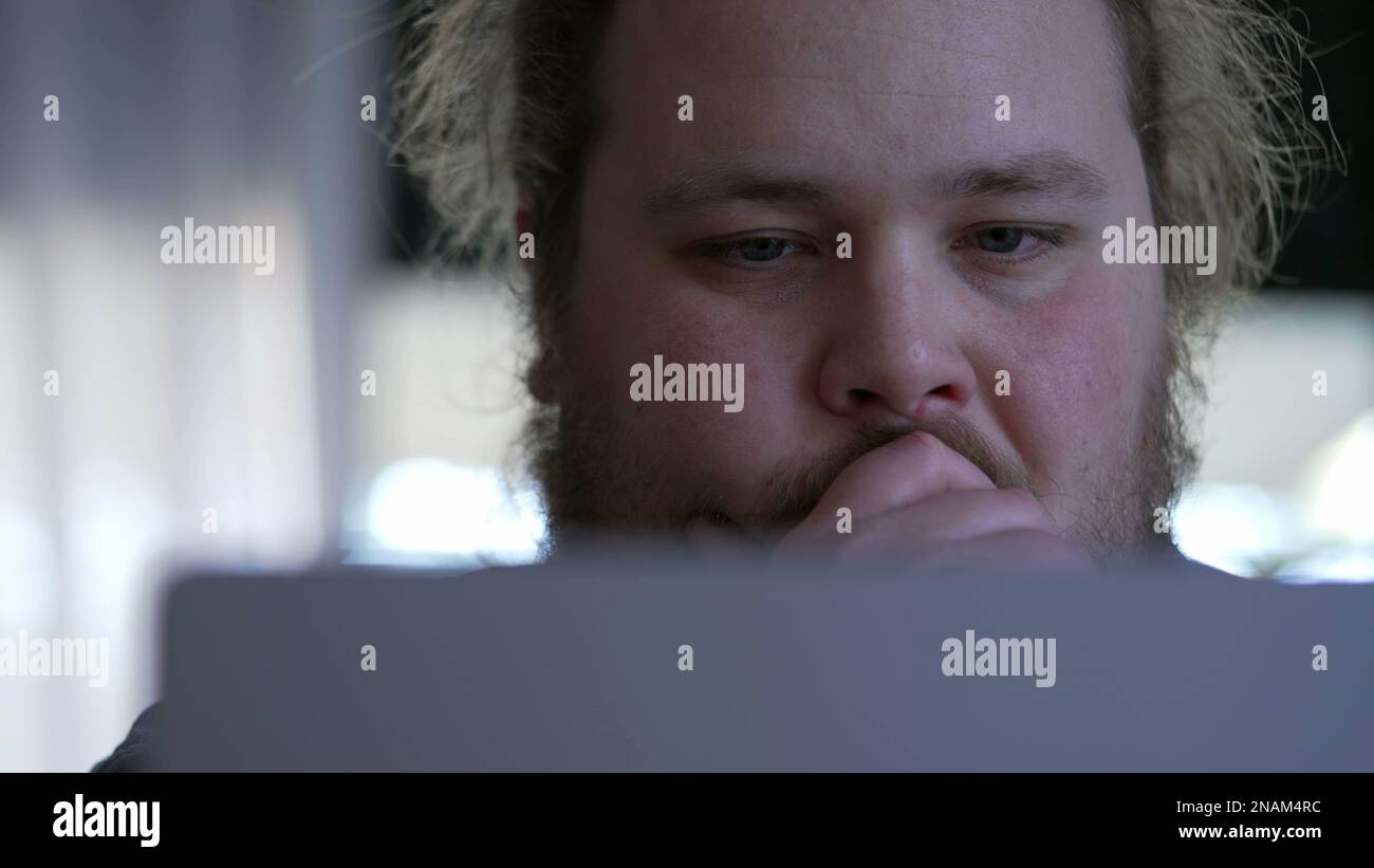 Close up face man working in front of computer screen with serious ...