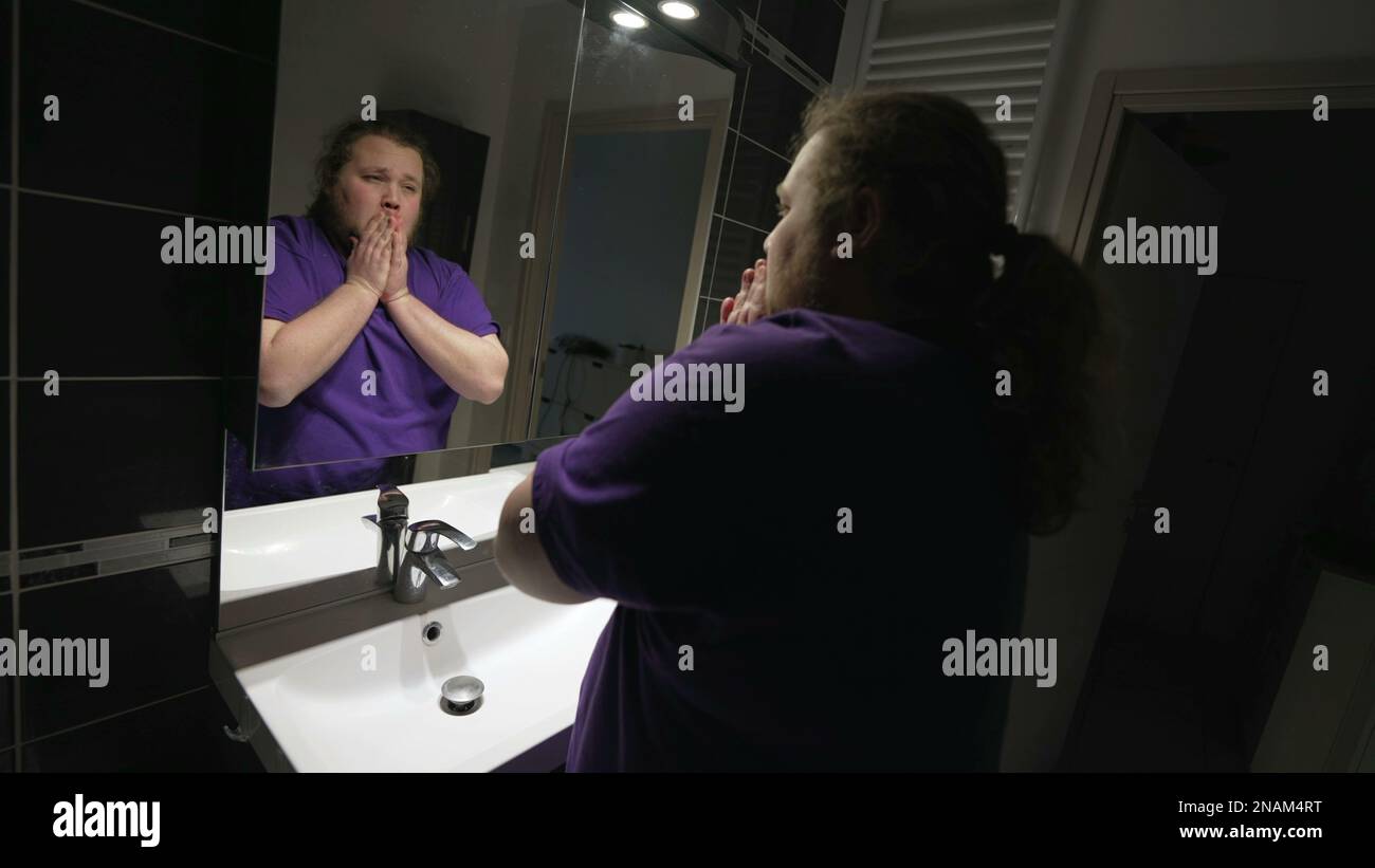 Confused sad man leaning on bathroom sink in dilemma and doubt. Person ...