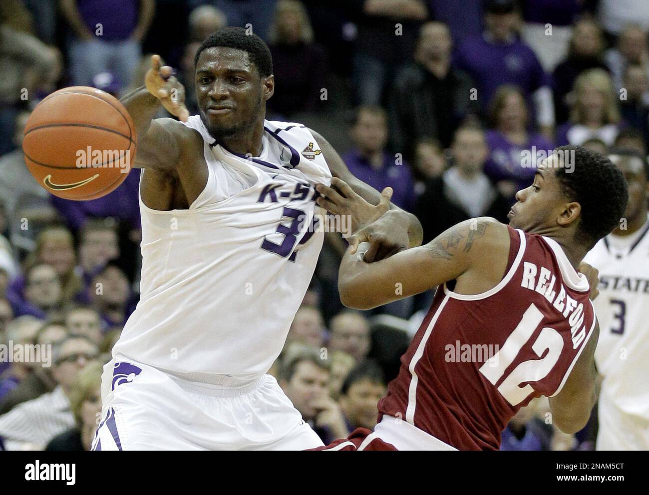 Kansas State forward Jamar Samuels, left, is fouled by Alabama guard ...