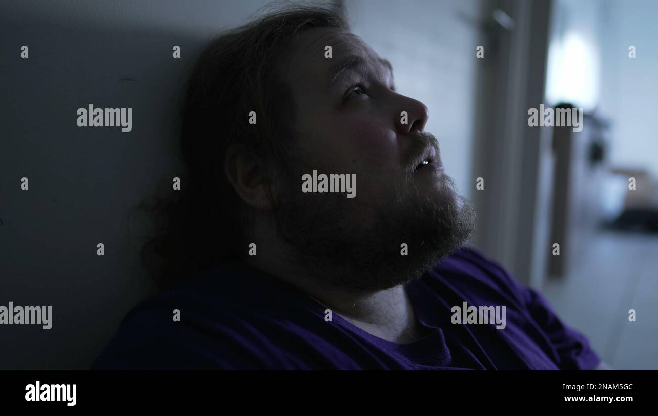 Depressed person sitting at home in the dark feeling despair Stock ...