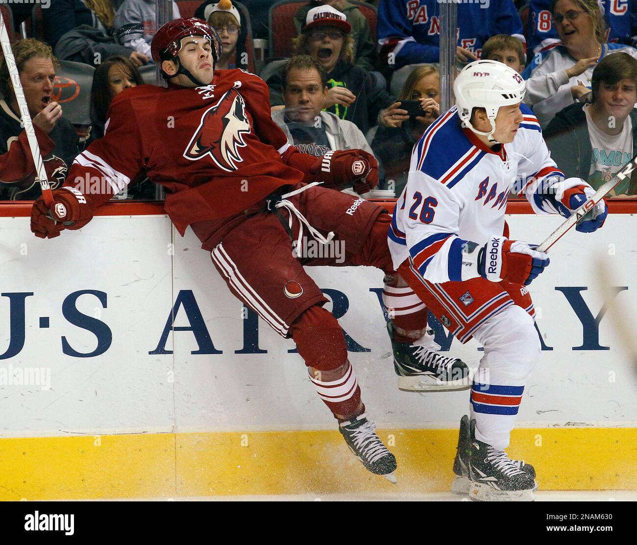 Phoenix Coyotes defenseman Keith Yandle, left, is checked by New York ...