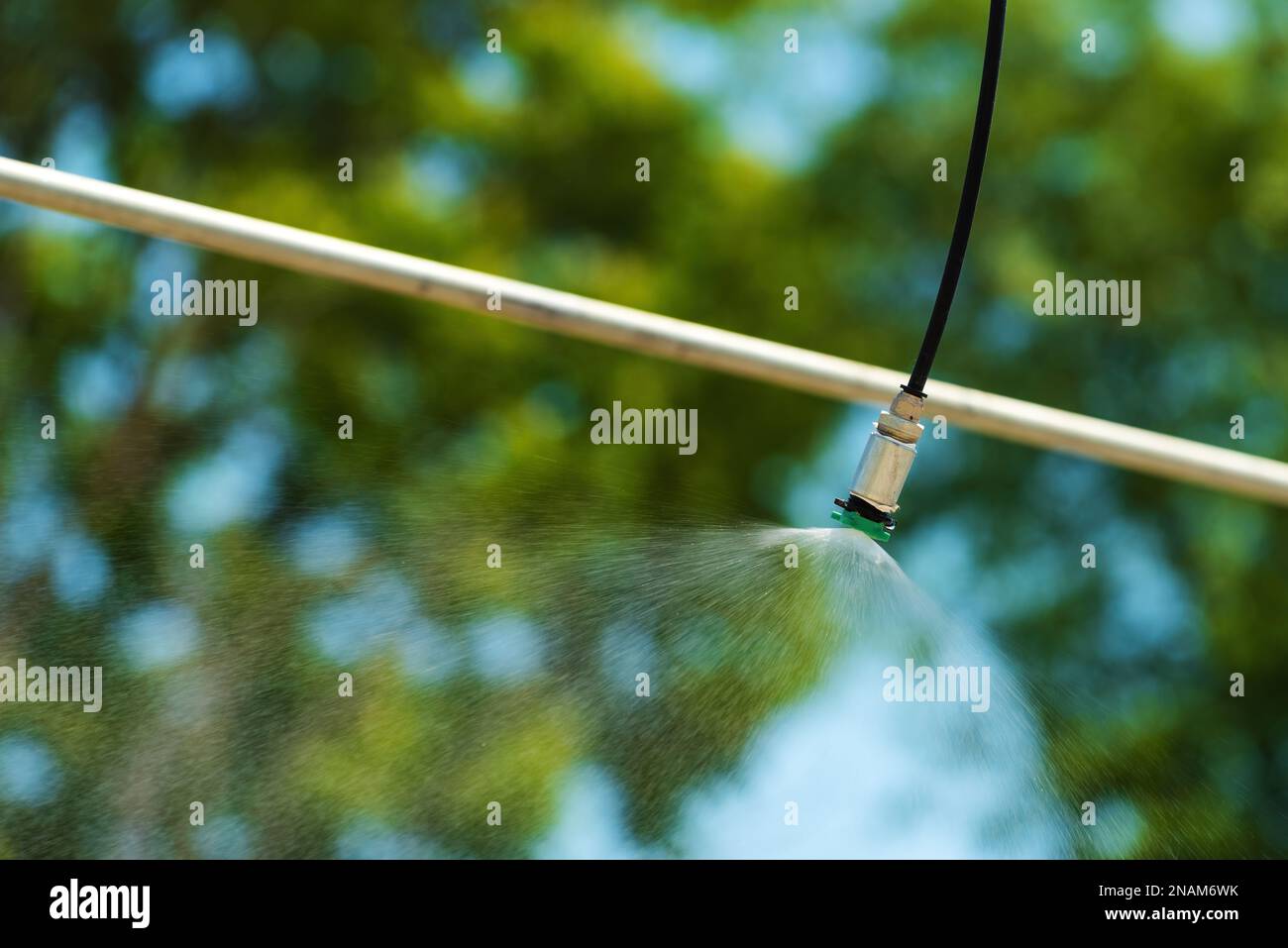 Agricultural sprinkler spraying the water drops over crops in ...