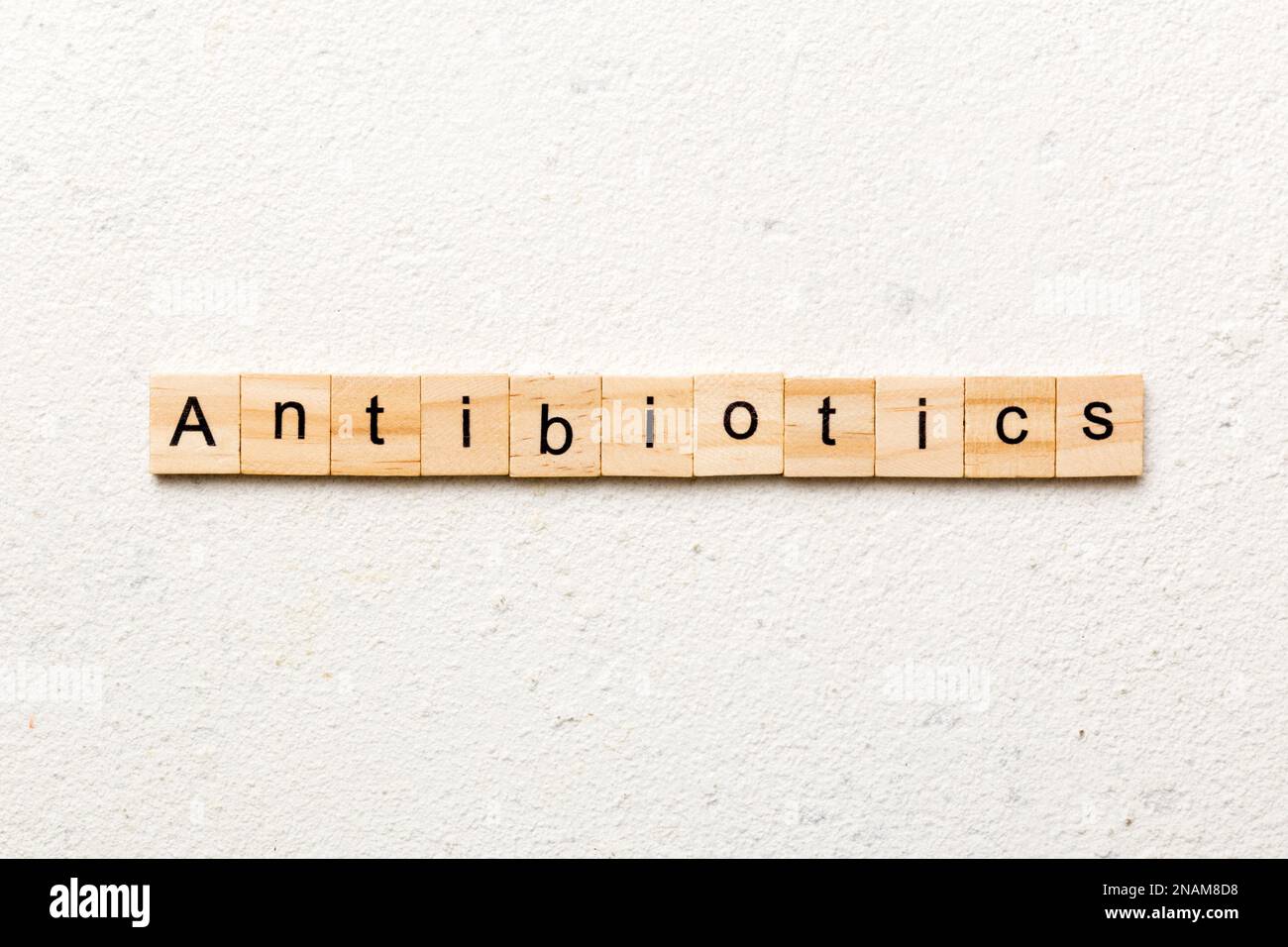 antibiotic word written on wood block. antibiotic text on table ...