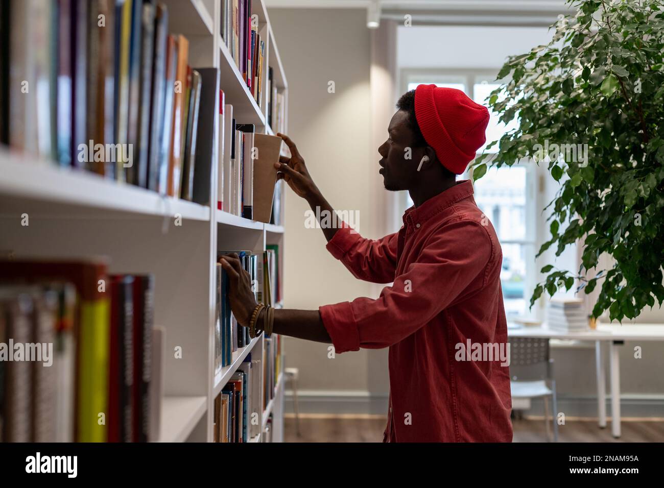 Concentrated black student guy picking literature checking information ...