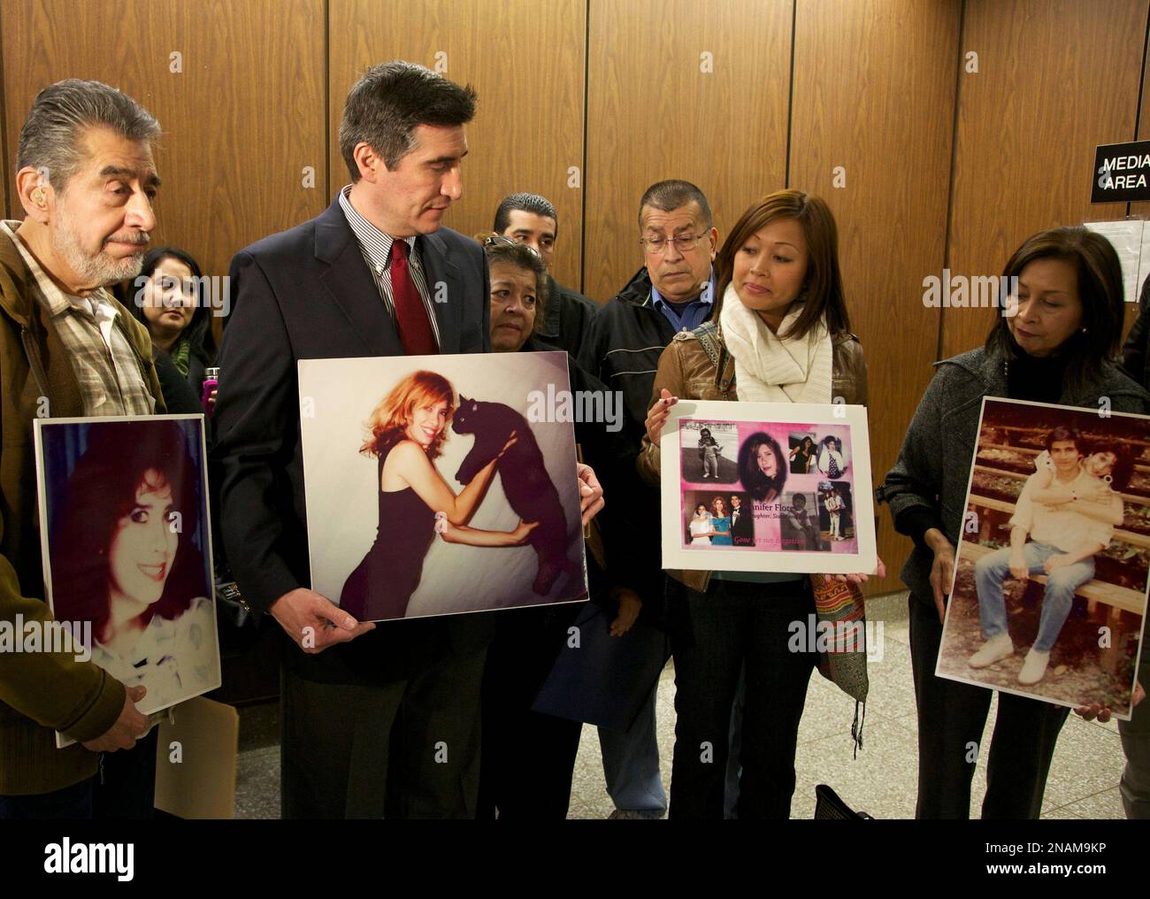 Family members of murder victim Jennifer Flores, hold photos of her at ...