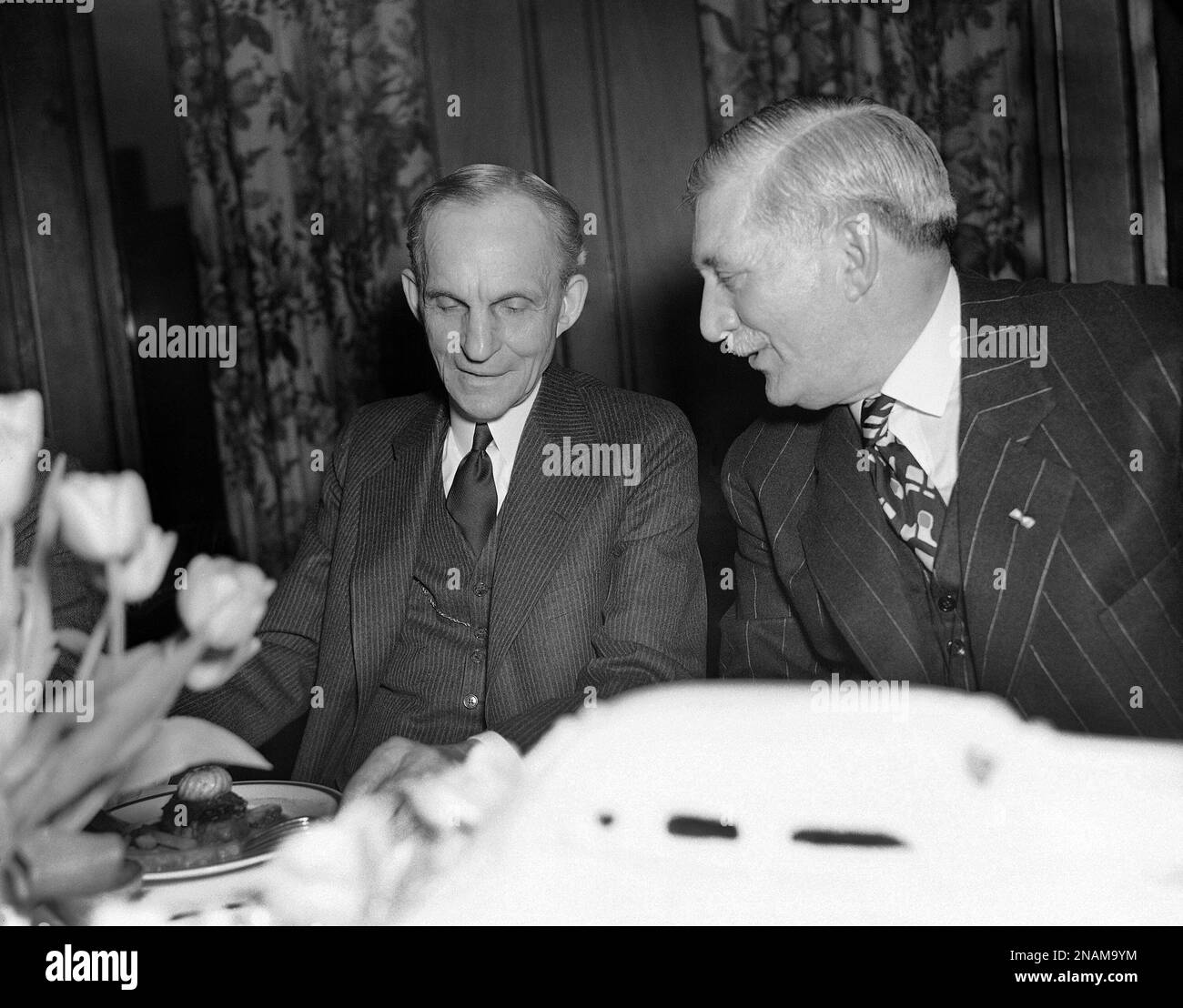 Henry Ford, left, chats with William S. Knudsen during Detroit luncheon ...