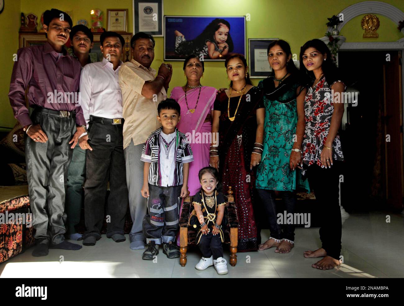 Jyoti Amge, 18, center, who stands at 61.95 centimeters (2 feet), poses ...
