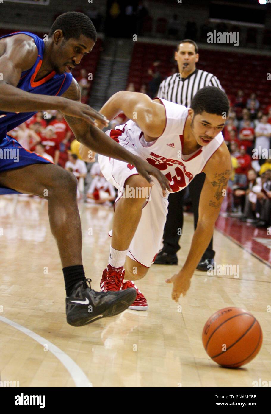 Savannah State's Arnold Louis, left, and Wisconsin's Rob Wilson go ...