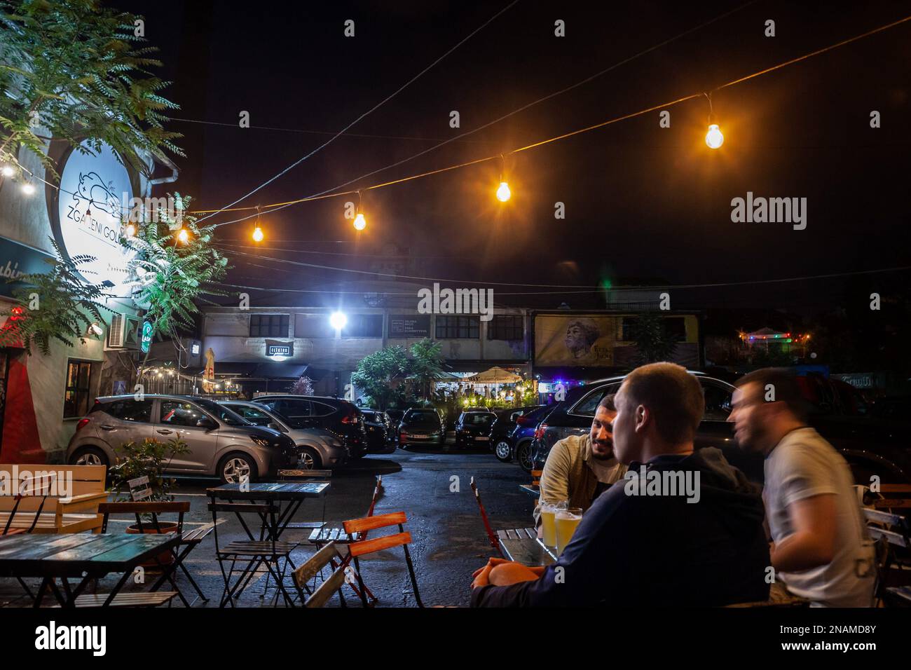 Picture of a group of young serbian men at night sitting and having fun ...